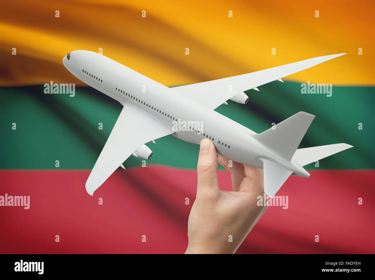 Airplane in hand with national flag on background - Lithuania Stock ...