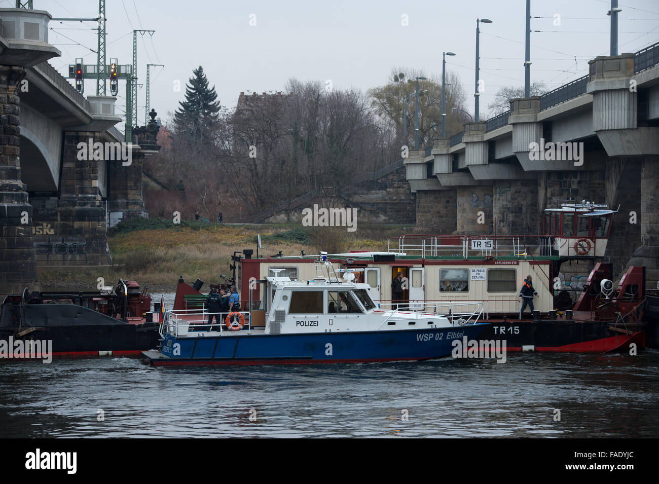 Dresden, Germany. 28th Dec, 2015. A police vessel moors to a push boat ...