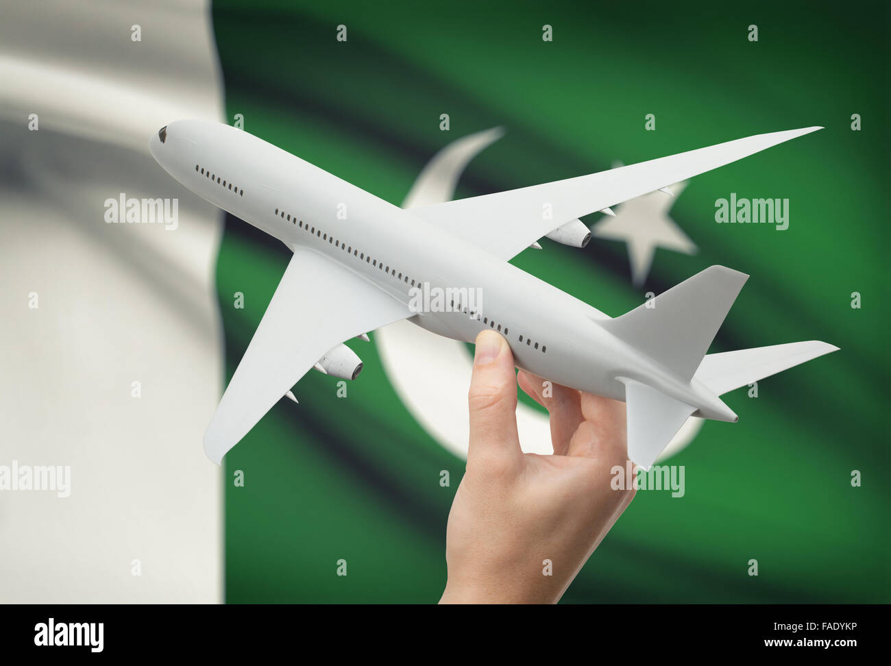 Airplane in hand with national flag on background - Pakistan Stock ...