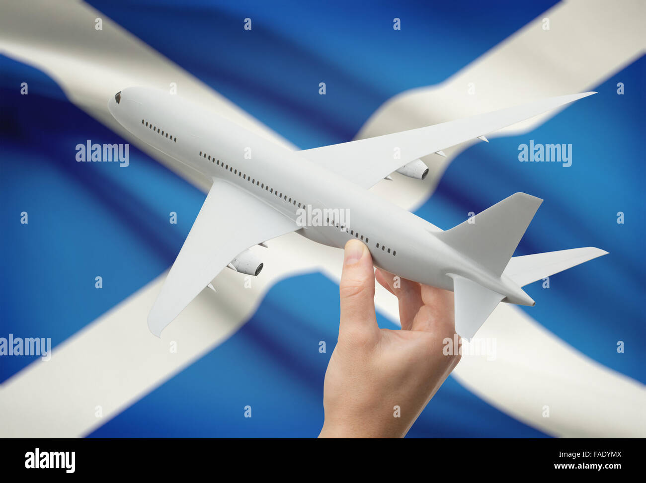 Airplane in hand with national flag on background - Scotland Stock ...