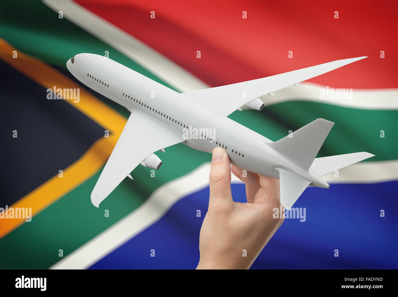 Airplane in hand with national flag on background - South Africa Stock ...