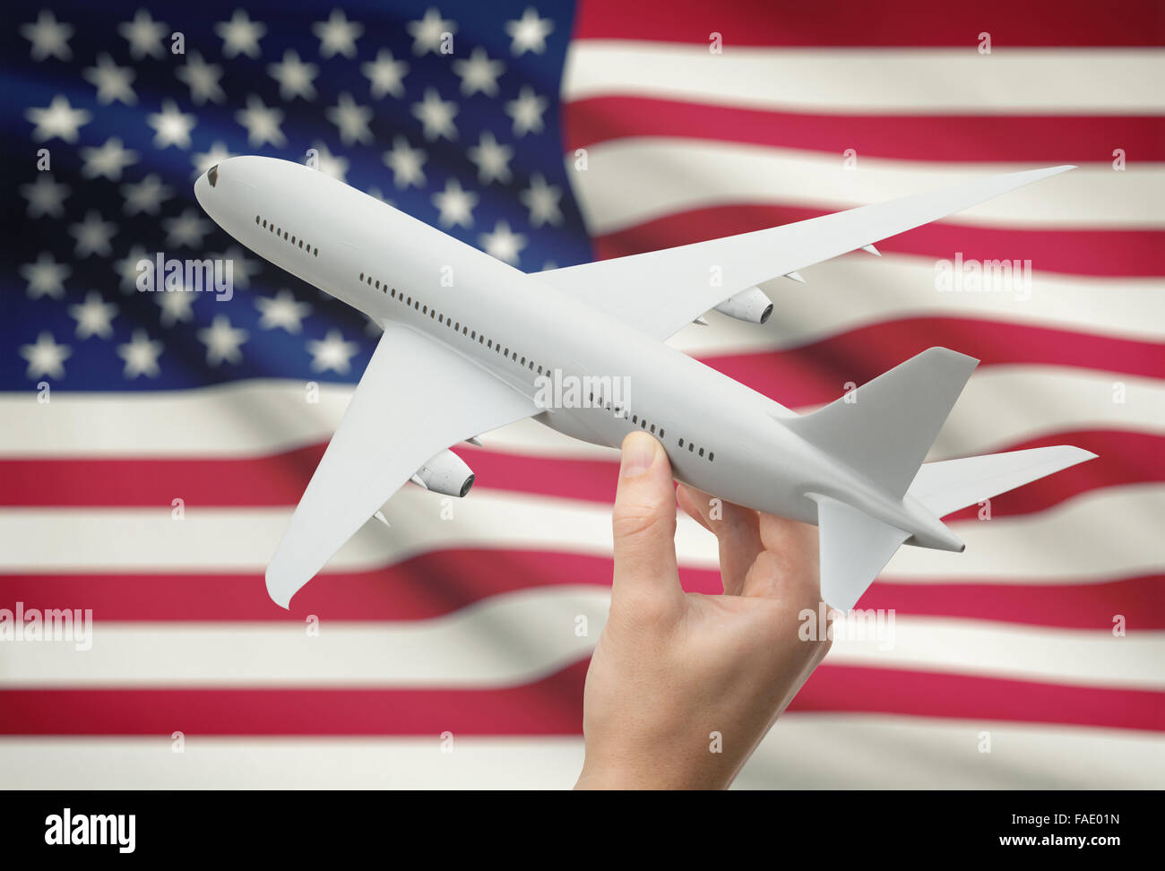 Airplane in hand with national flag on background - United States Stock ...