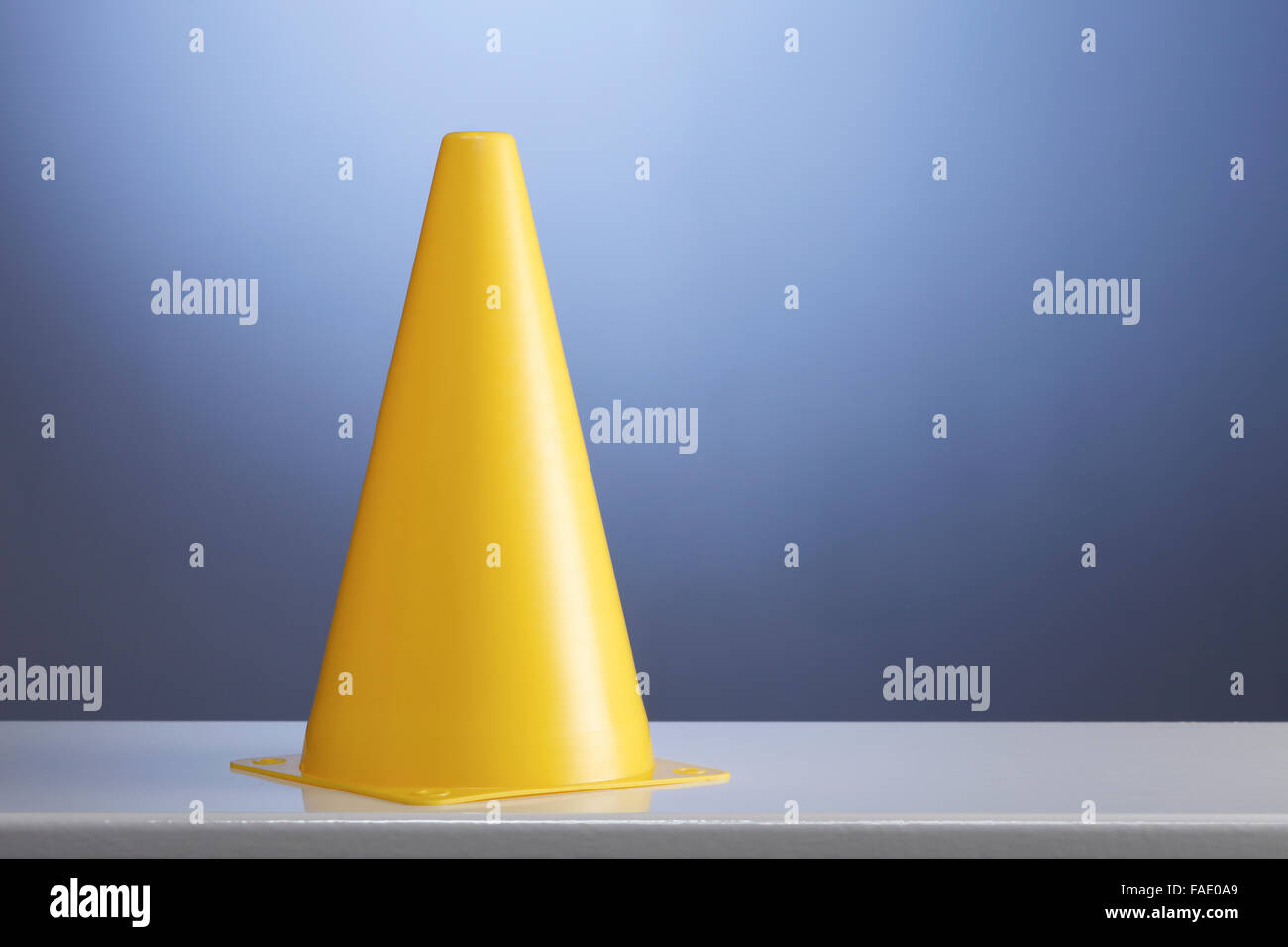 Yellow cone on white background with copy Stock Photo - Alamy
