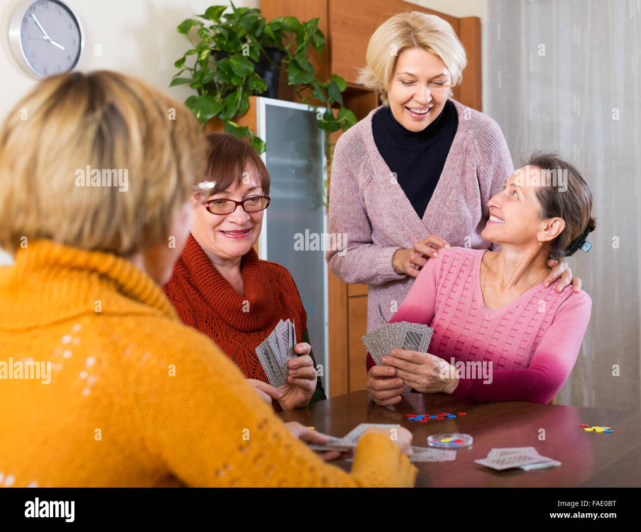 Positive european senior female friends staking money during bridge ...