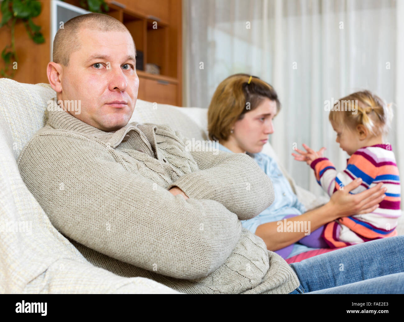 Family quarrel. Sadness man against unhappy crying woman at home Stock ...