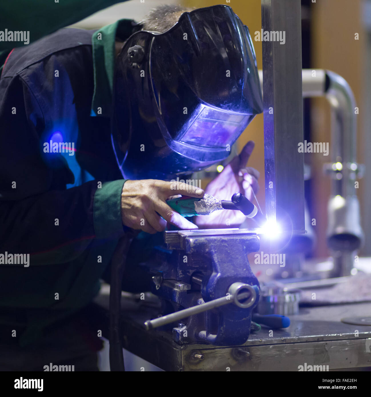 Industrial worker welding in metal factory Stock Photo - Alamy