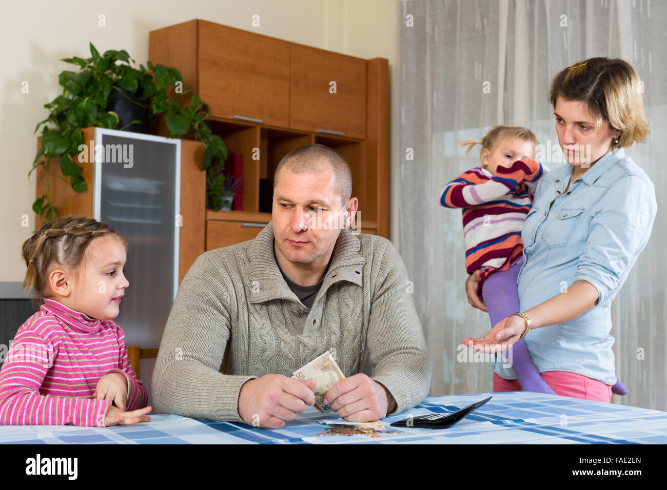 Financial problems in family. Unhappy young woman with children against ...