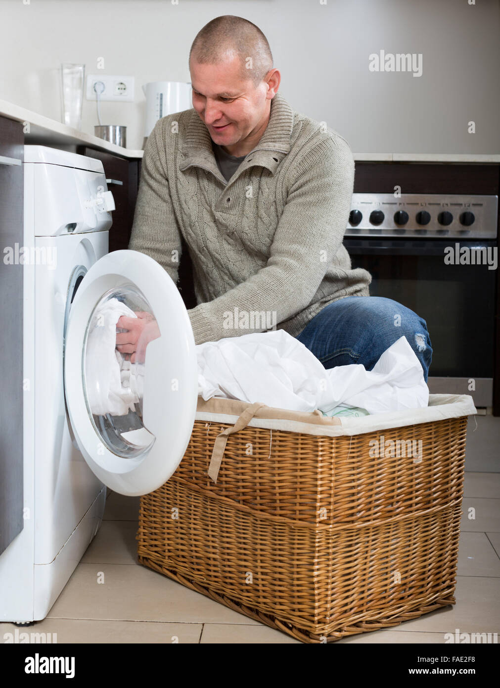 Home laundry smiling guy using hi-res stock photography and images - Alamy