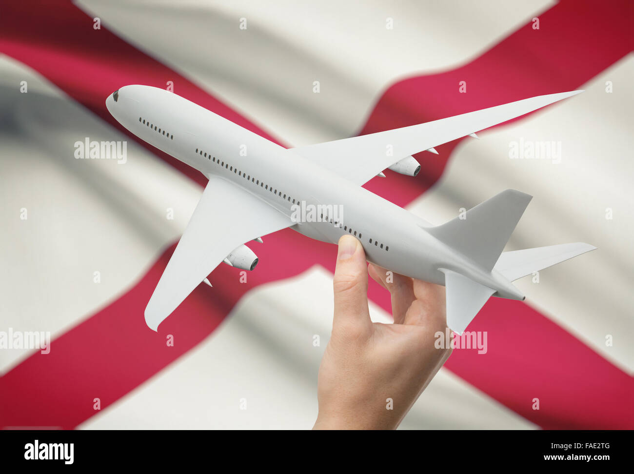 Airplane in hand with local US state flag on background - Alabama Stock ...