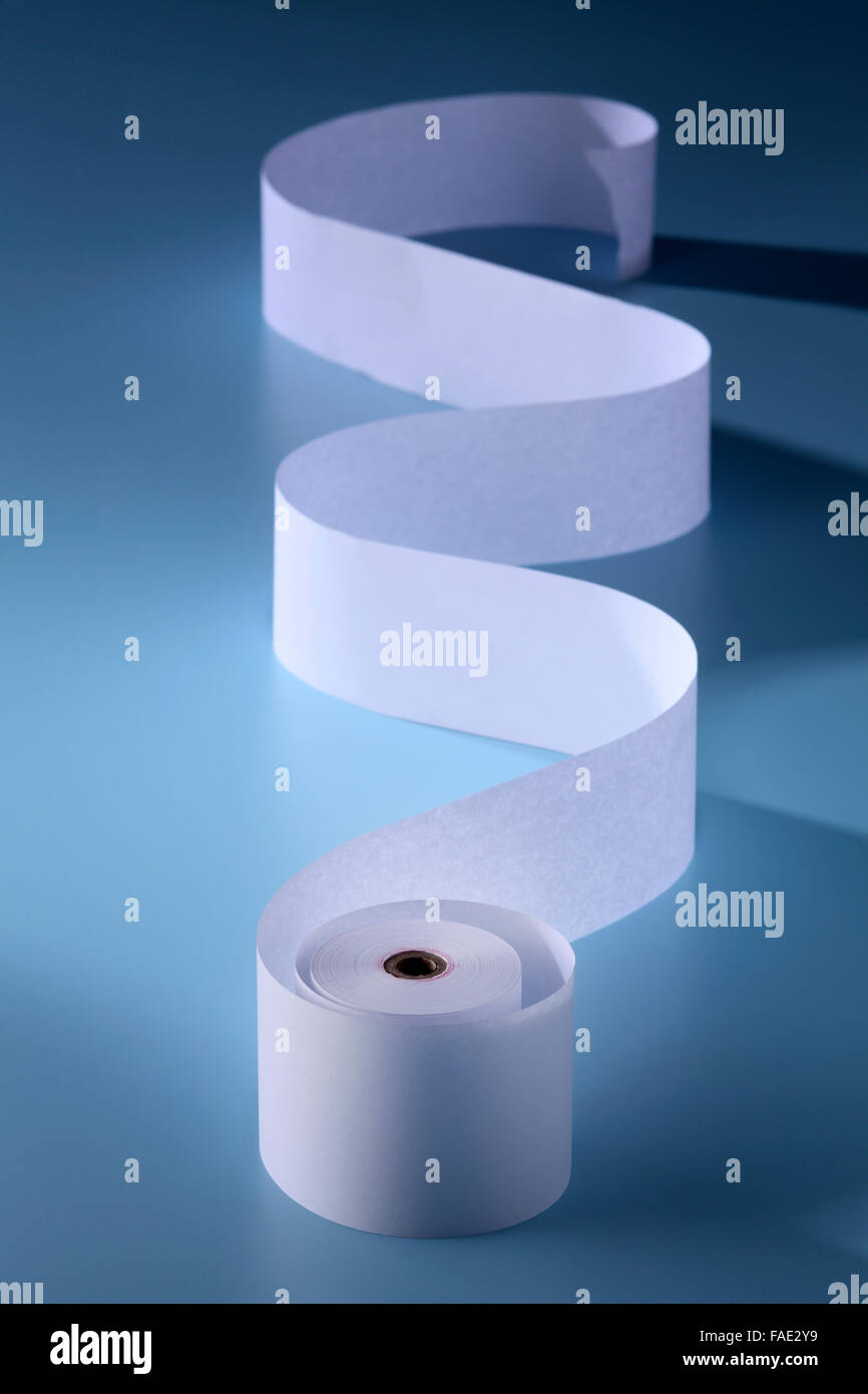 Roll of paper curling on the blue background Stock Photo - Alamy
