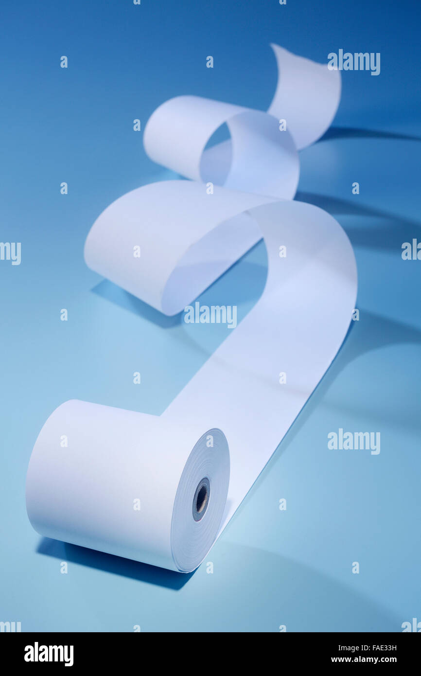 Roll of paper curling on the blue background Stock Photo - Alamy