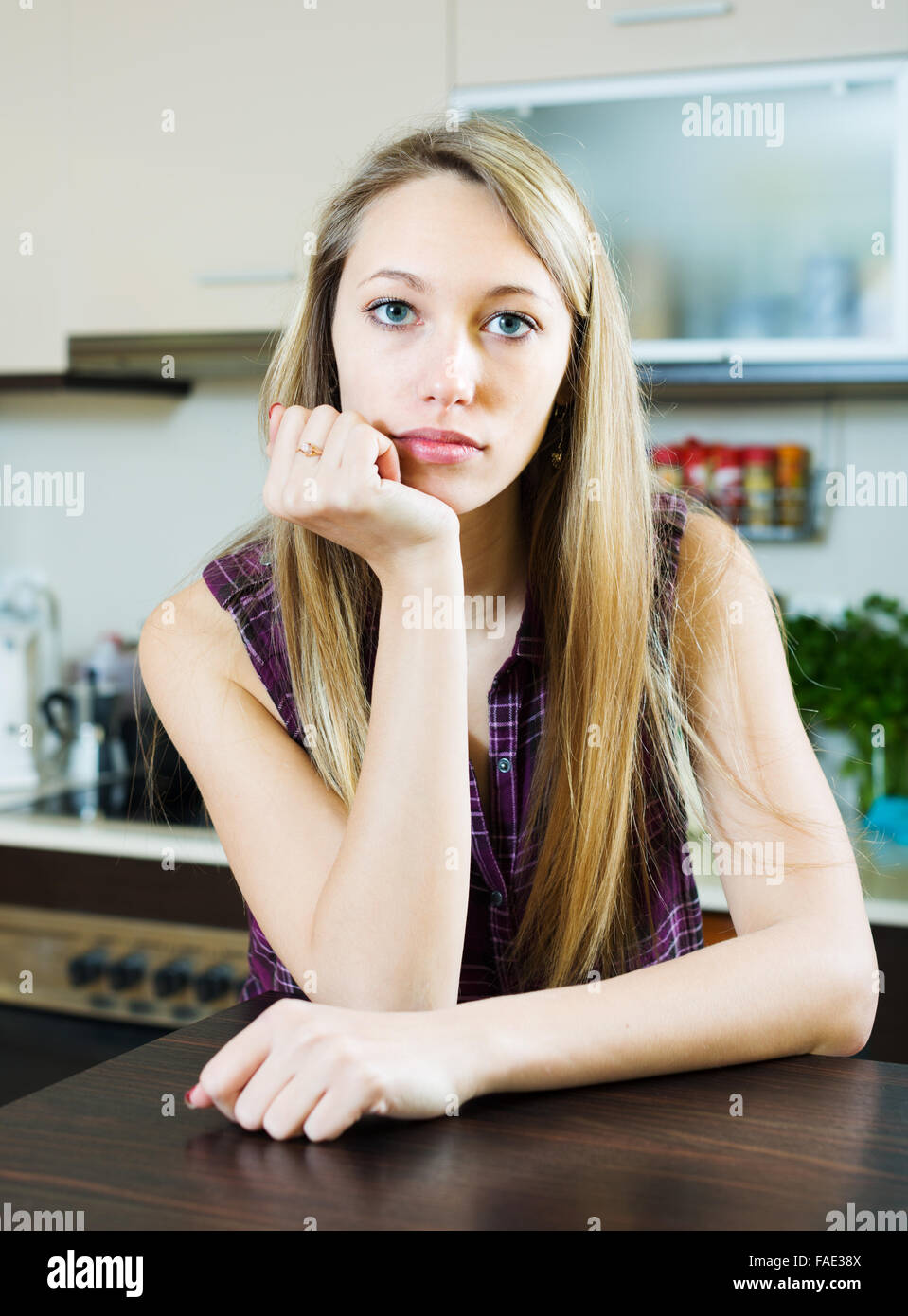 lonely sad houswife sitting at kitchen Stock Photo - Alamy