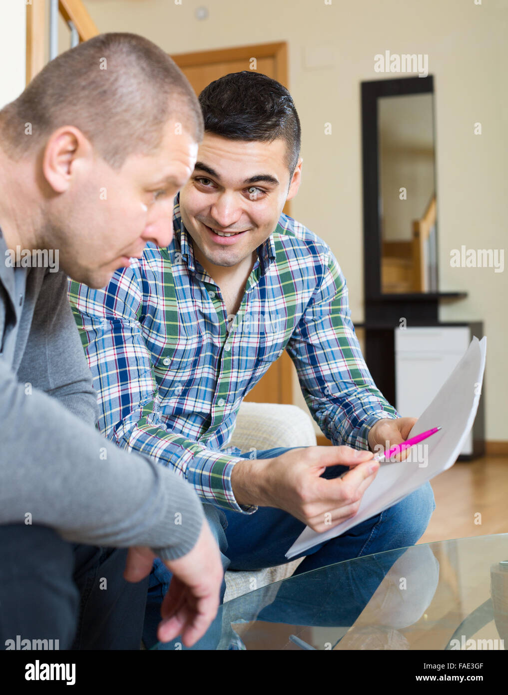 Agent And Client Discussing Tenancy Agreement At New Apartment Stock agent-and-client-discussing-tenancy-agreement-at-new-apartment-stock