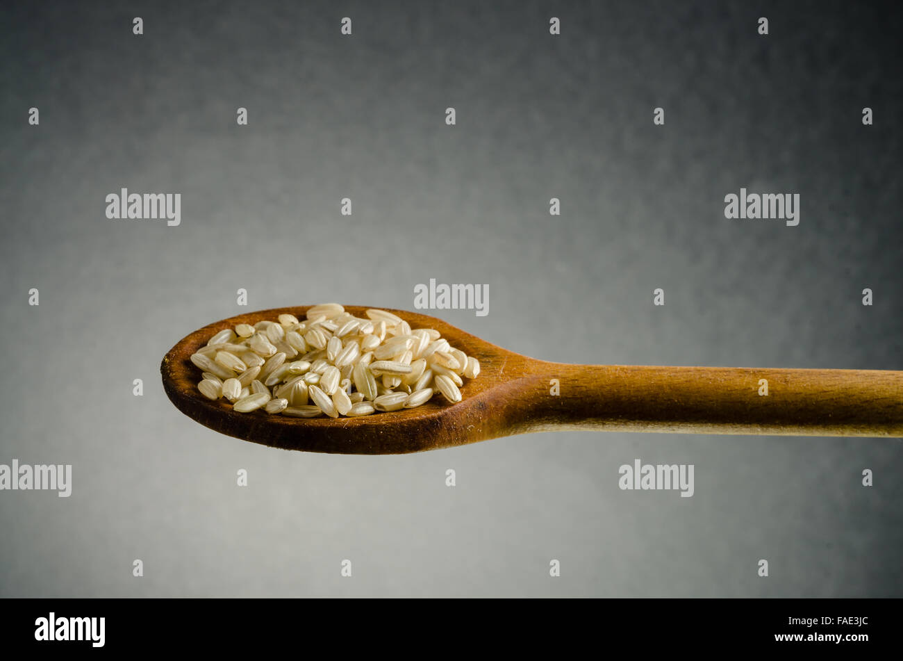 rice in a spoon, close up, color background Stock Photo - Alamy