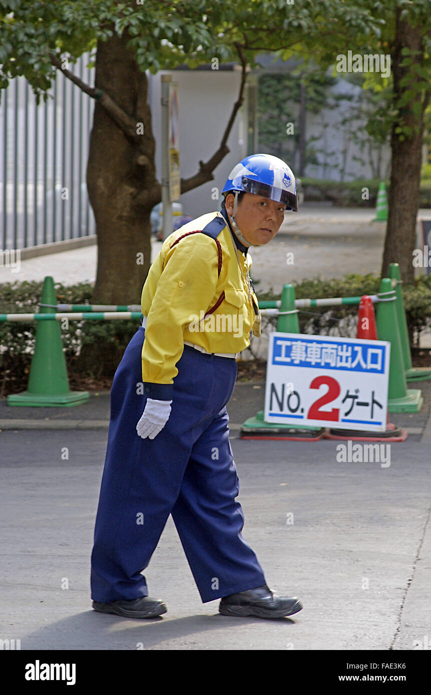 Female road traffic safety controller in Tokyo Stock Photo - Alamy