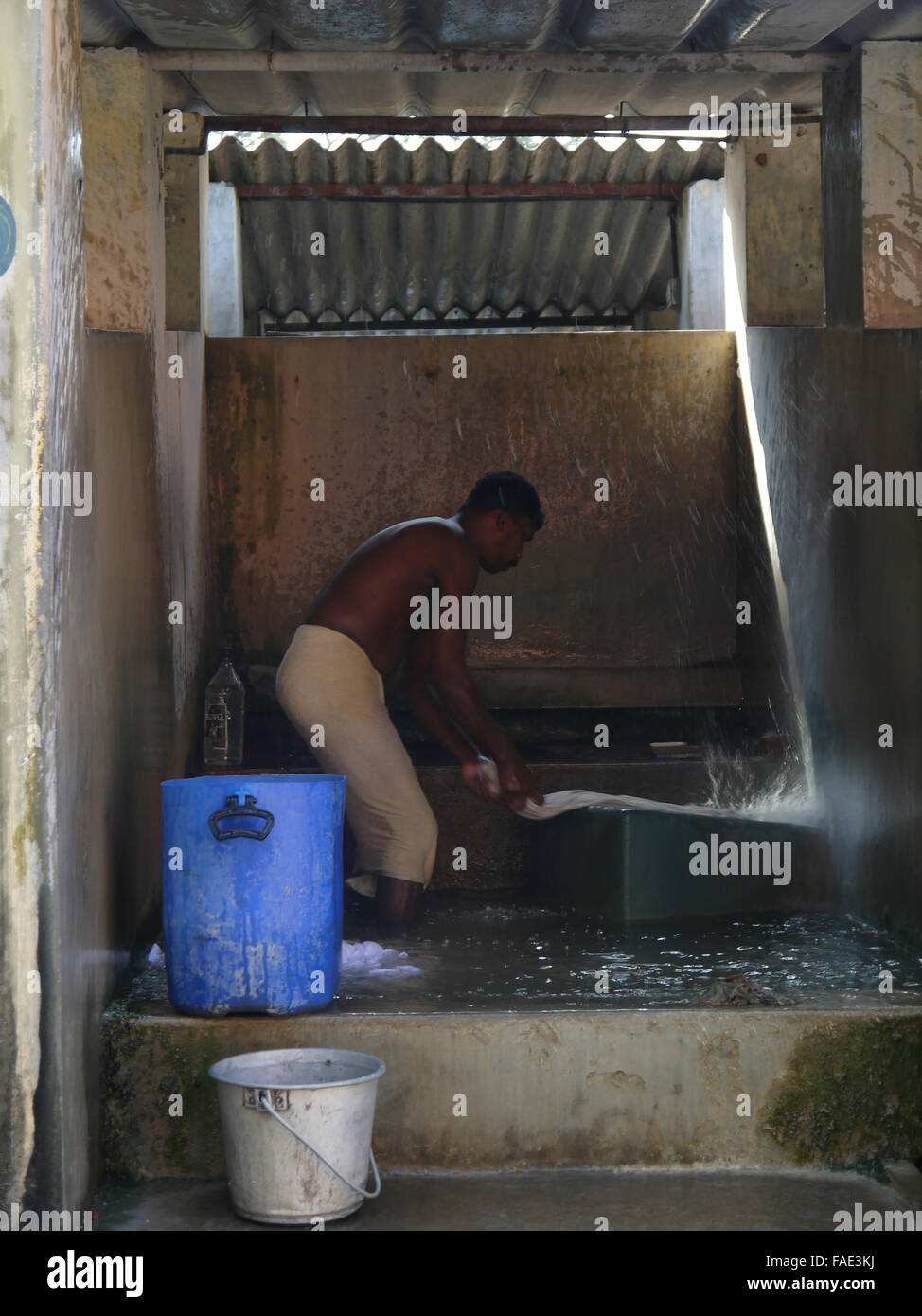 Community laundry worker washing clothes - Community Laundry Stock ...