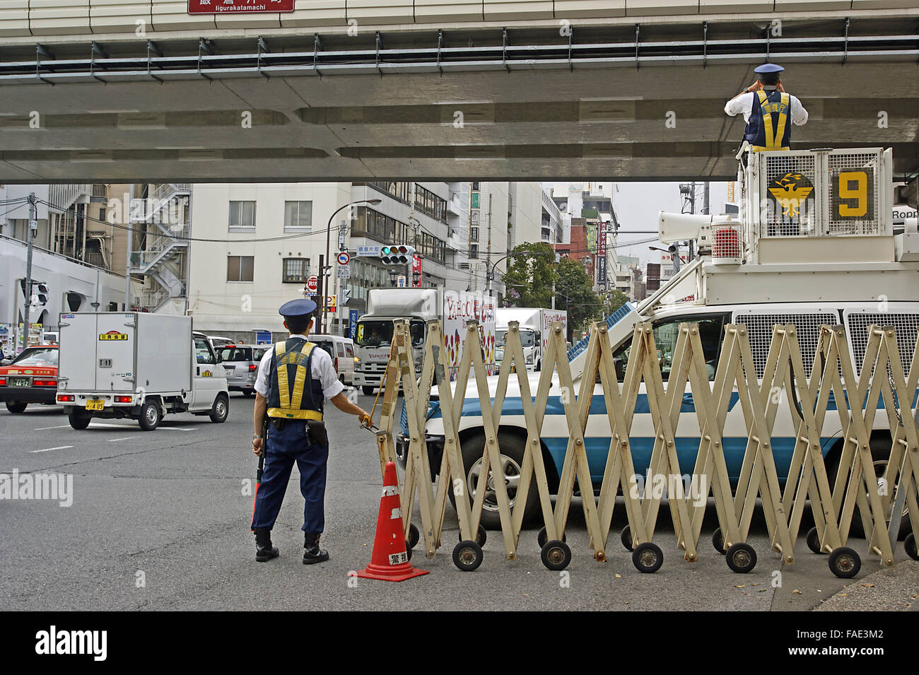 Japanese riot squad police keeping an eye out for trouble on a mobile ...