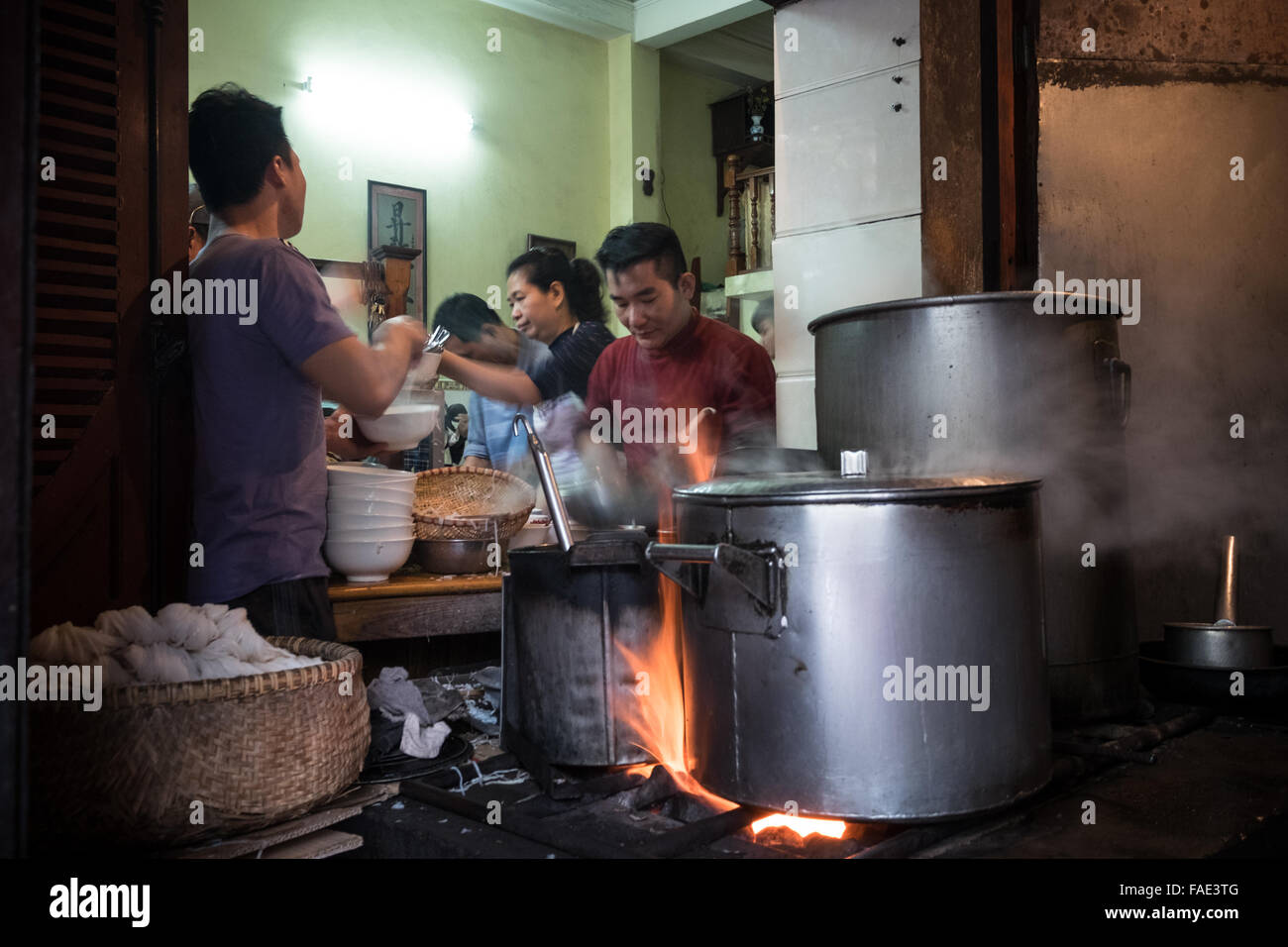 Staff preparing bowls of Pho Bo (beef noodle soup) at the iconic Pho ...