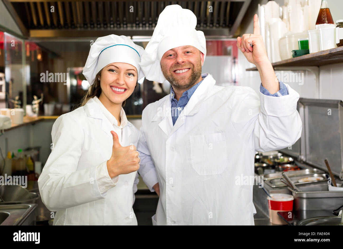 Positive professional chef and cook working in restaurant kitchen Stock ...