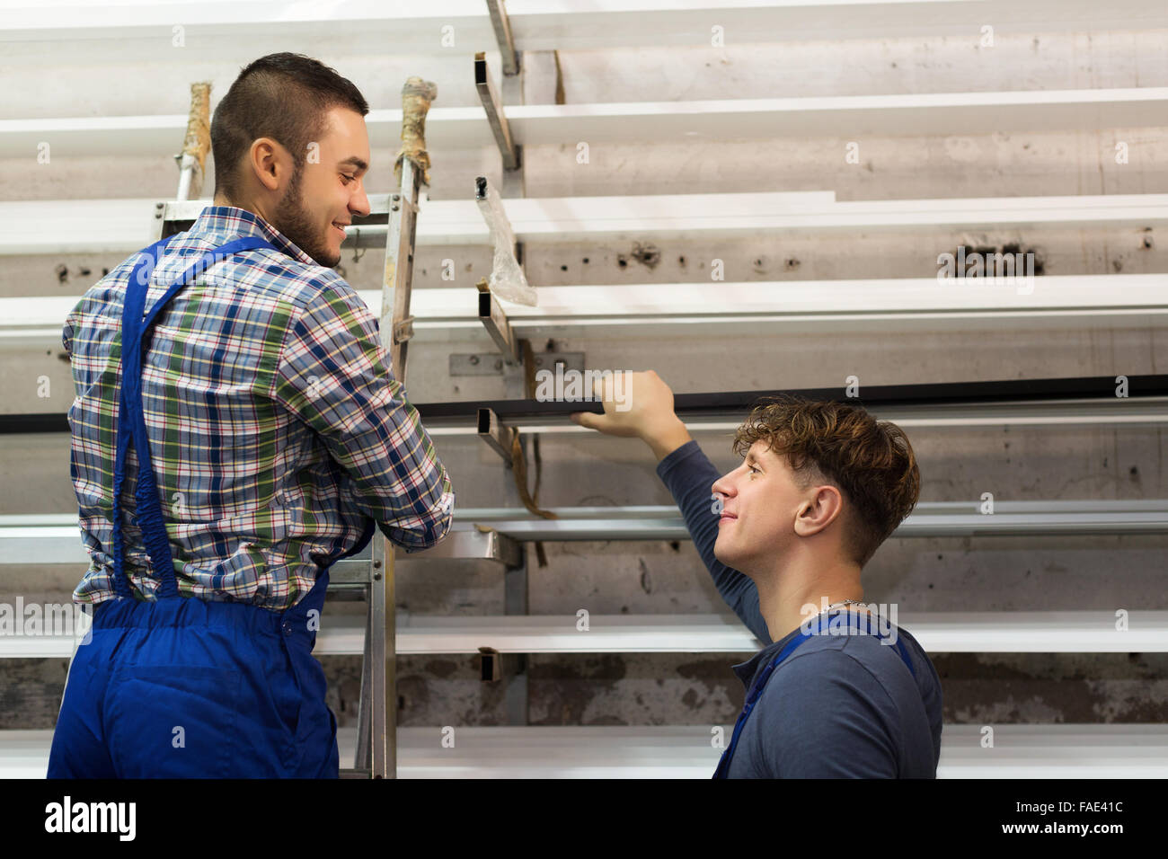 Production workers in uniform with different PVC window profiles Stock ...