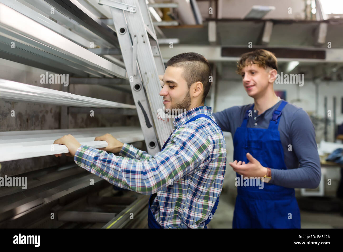 Workmen choosing window profiles at factory Stock Photo - Alamy