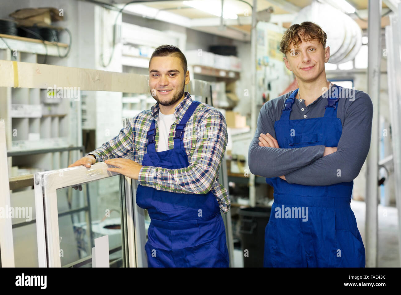 Production workers in coverall with different PVC window Stock Photo ...
