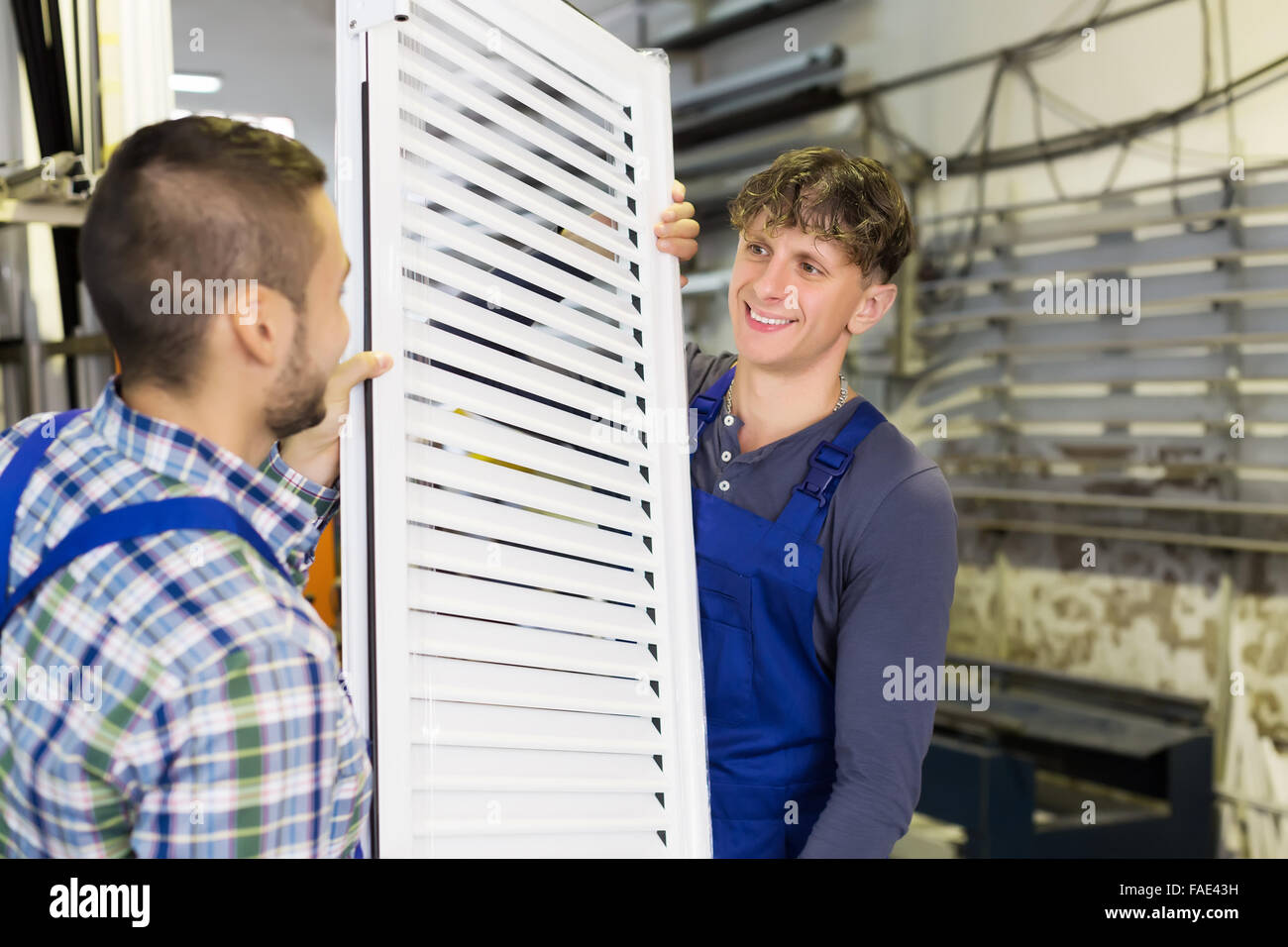 workers with PVC window with shutter Stock Photo - Alamy