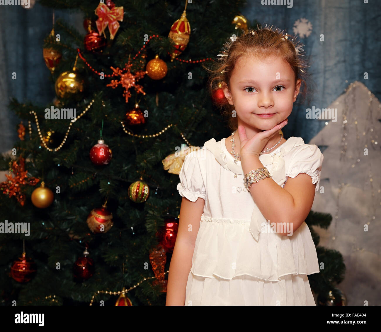 Beautiful cute little kid girl posing in fashion white dress and silver ...