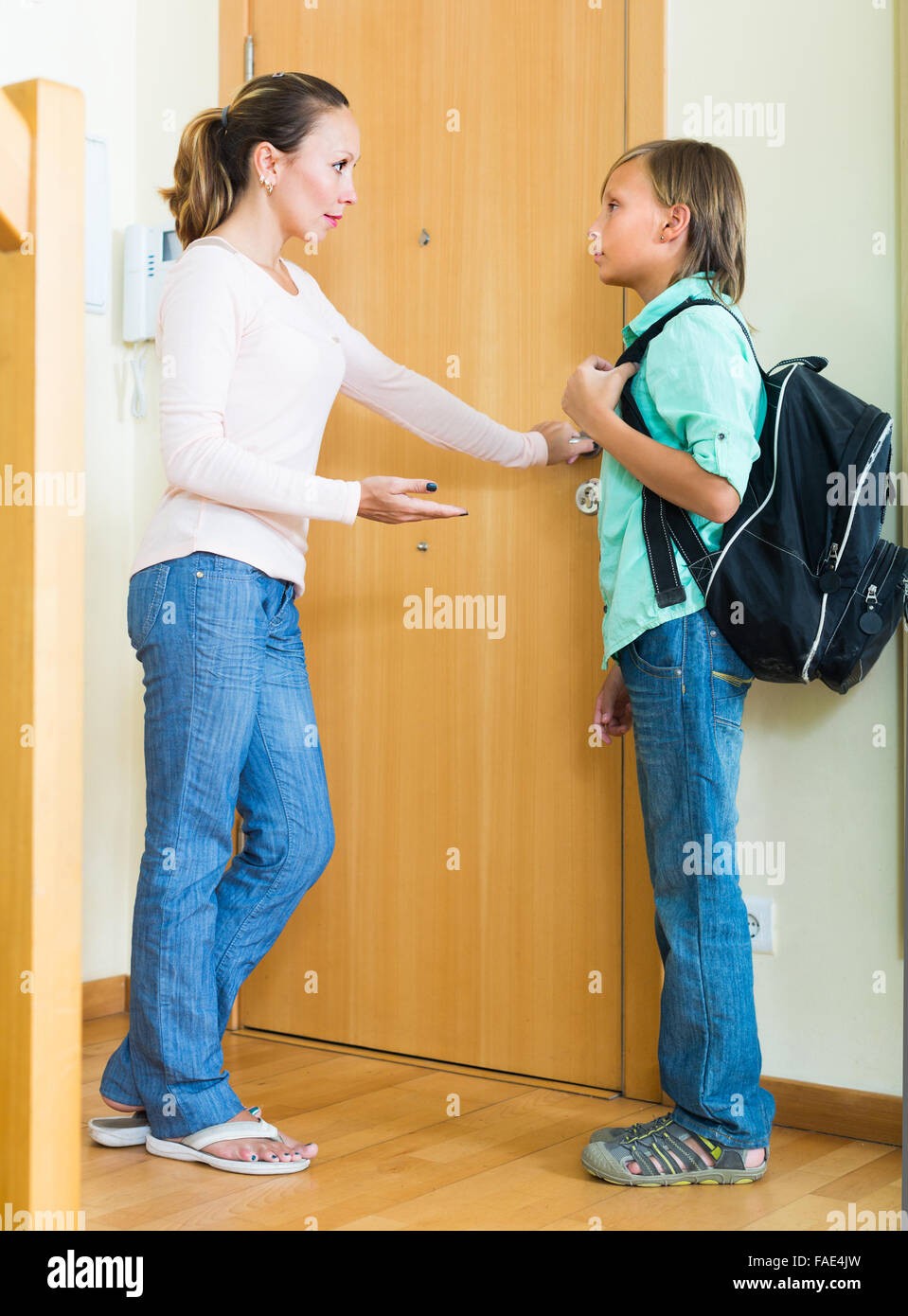 Positive mature woman lecturing boy before he goes to school Stock ...