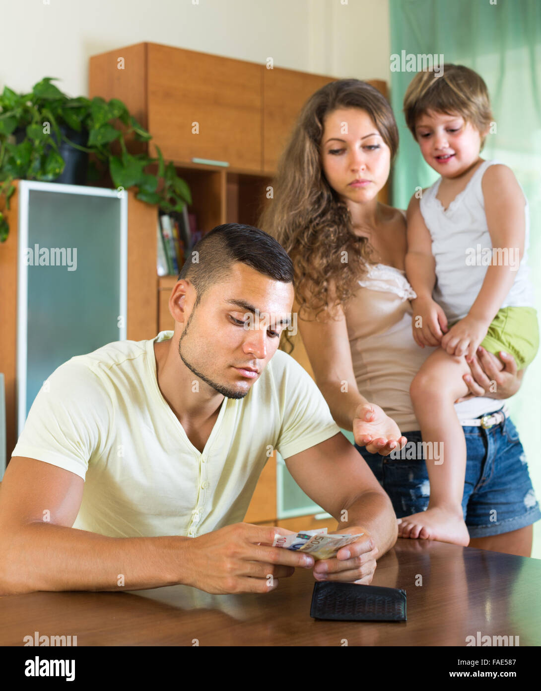 Young family with child having financial problems. Focus on man Stock ...