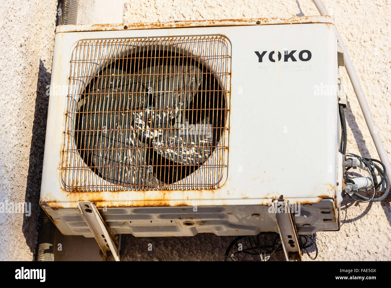 Old, rusty and weathered air condition unit on overhead bracket ...