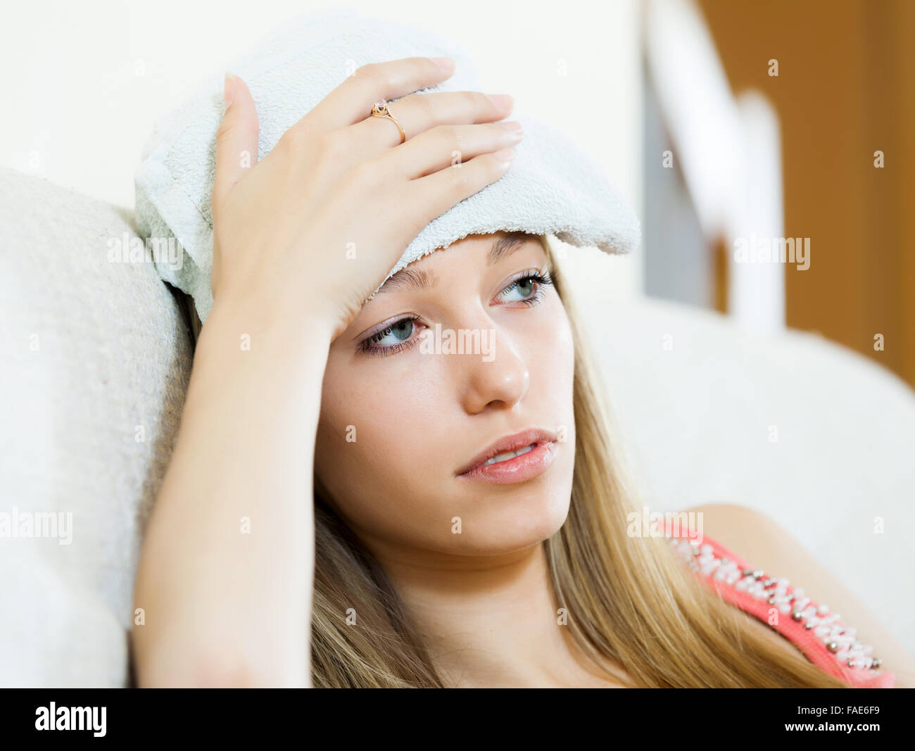 Tired of problems girl sitting on sofa Stock Photo - Alamy