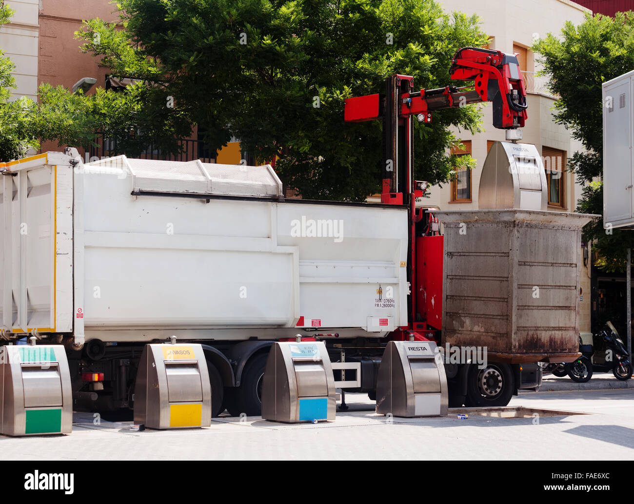Garbage truck collecting garbage dumpster at city street Stock Photo ...