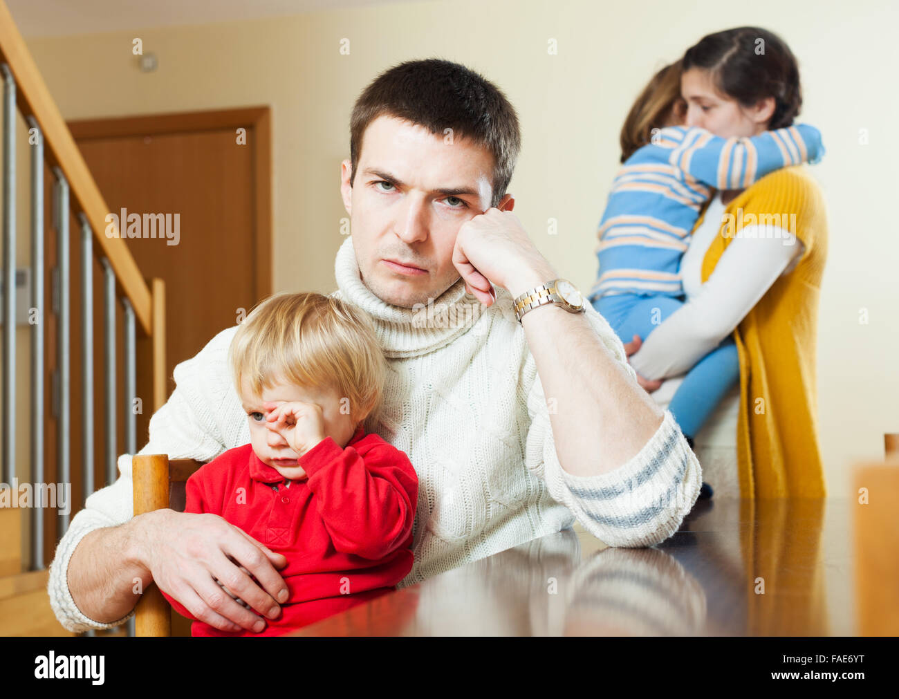 Family with two children after quarrel in home Stock Photo - Alamy