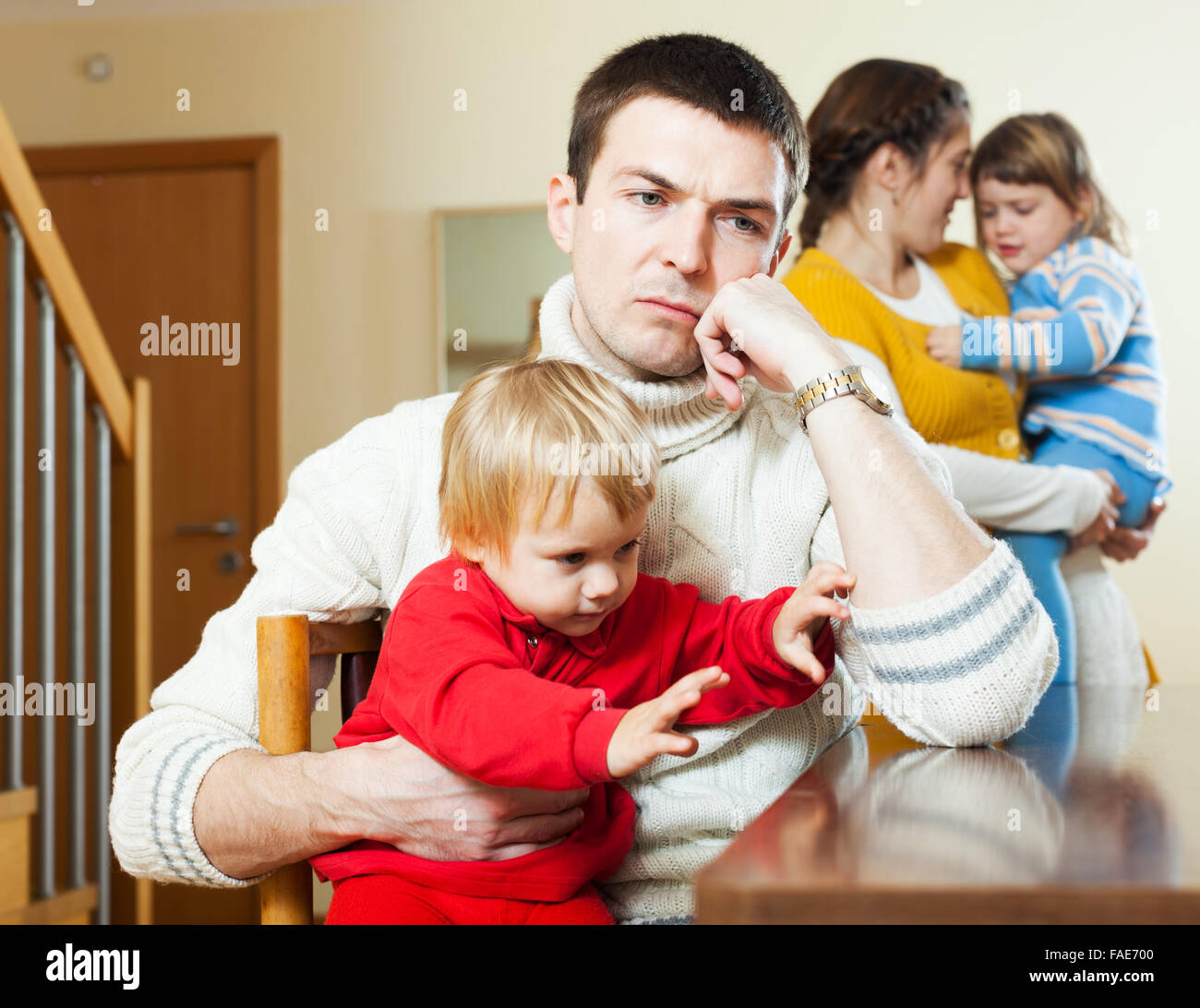 Family of four with two children having quarrel Stock Photo - Alamy