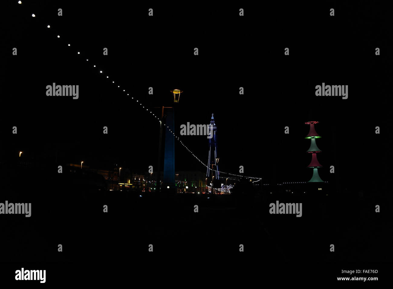 Night view, south to blue Cenotaph and Blackpool Tower, red green ...