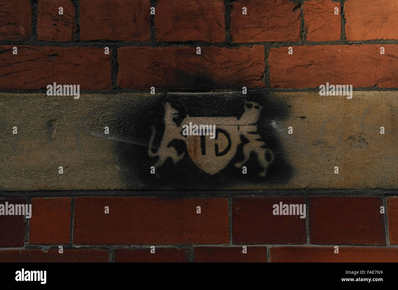 Stencil heraldic animals side of shield with 'TD' initial, stone plinth ...