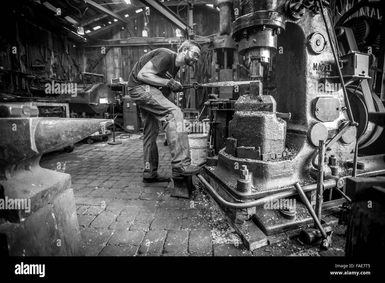 Blacksmith working in forge Stock Photo - Alamy