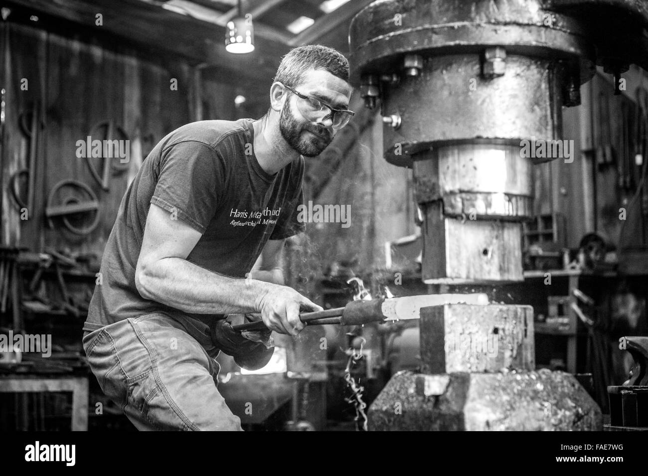 Blacksmith hammering Black and White Stock Photos & Images - Alamy