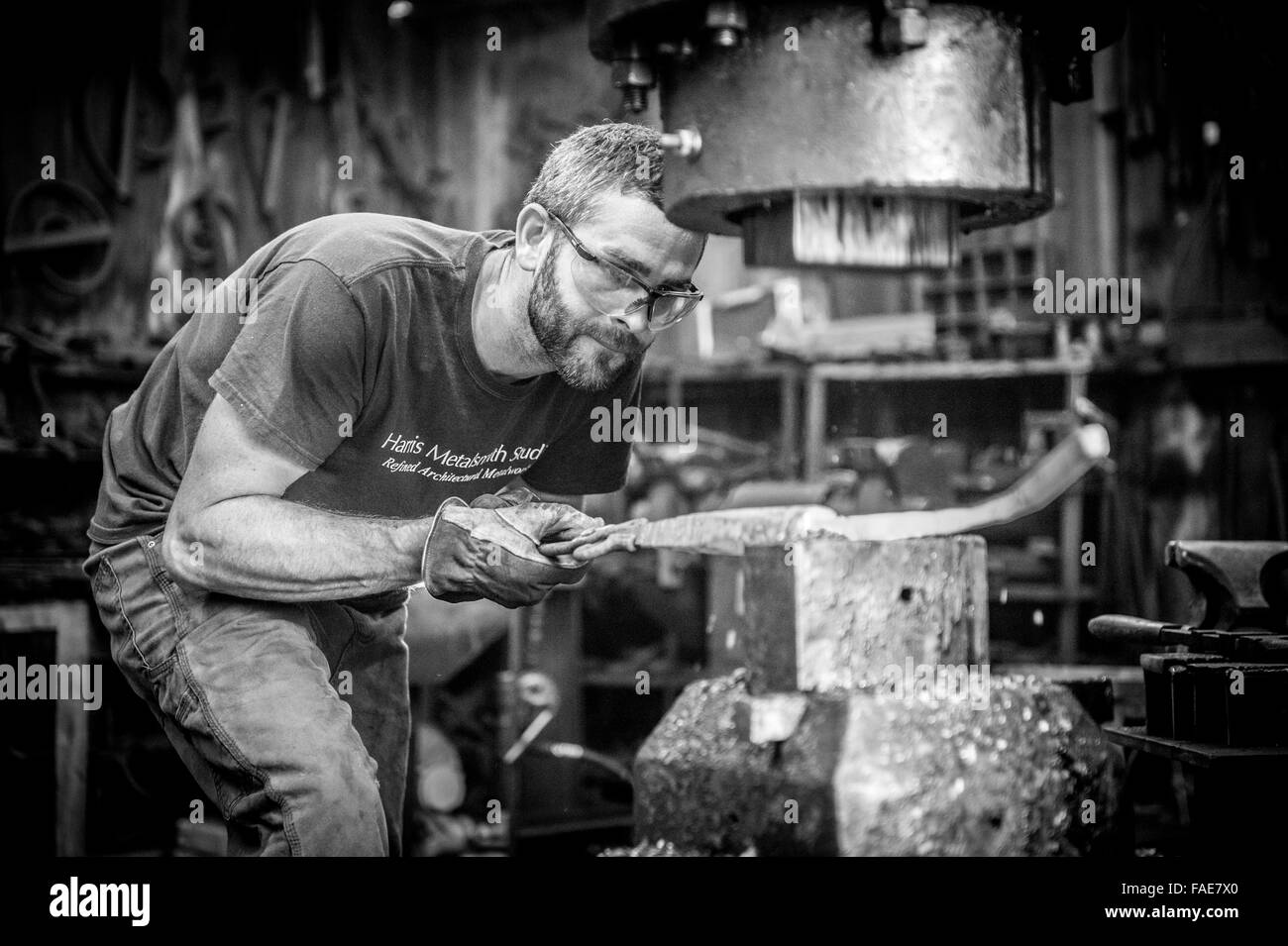 Blacksmith working in forge Stock Photo - Alamy