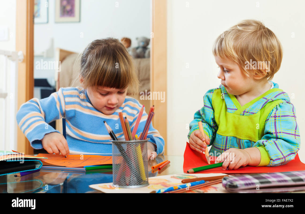 children together with pencils in home interior Stock Photo - Alamy