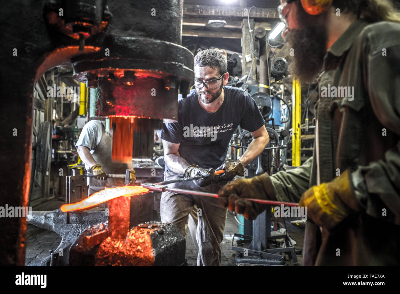Blacksmith working in forge Stock Photo - Alamy
