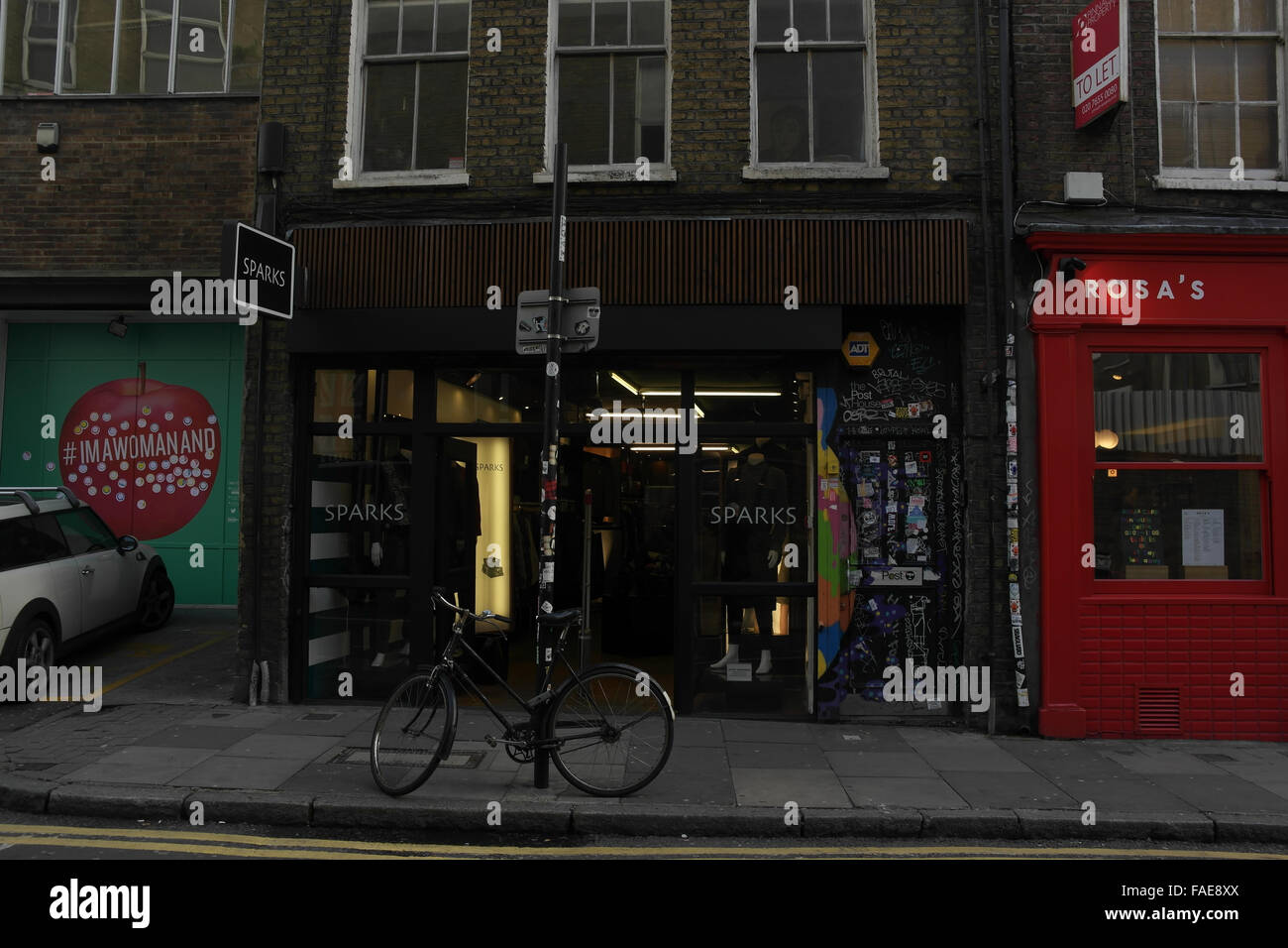 View of bicycle secured lamp-post in front of Sparks Clothes Shop next ...