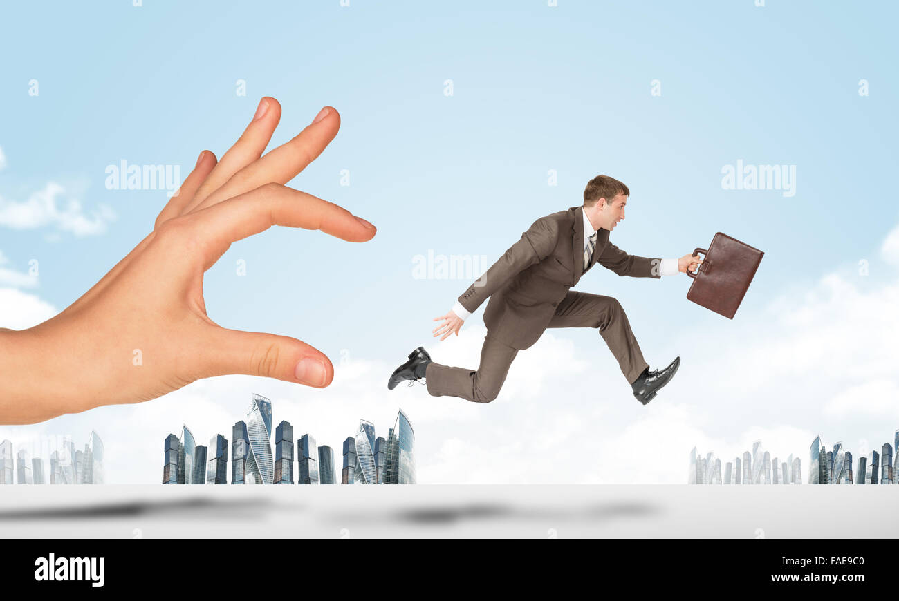 Hand catching businessman running forward Stock Photo - Alamy