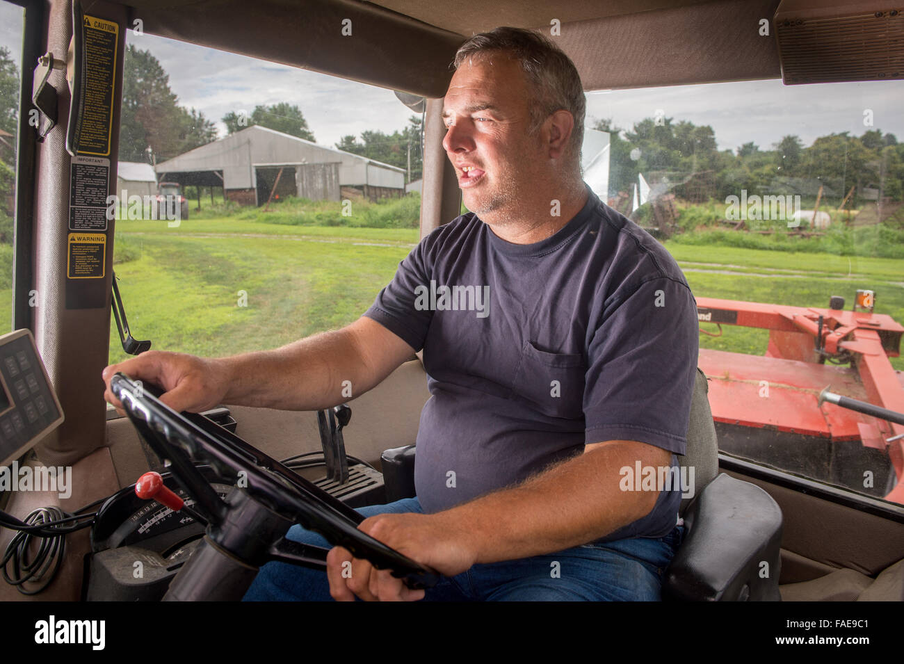 Farmer driving his tractor Stock Photo - Alamy