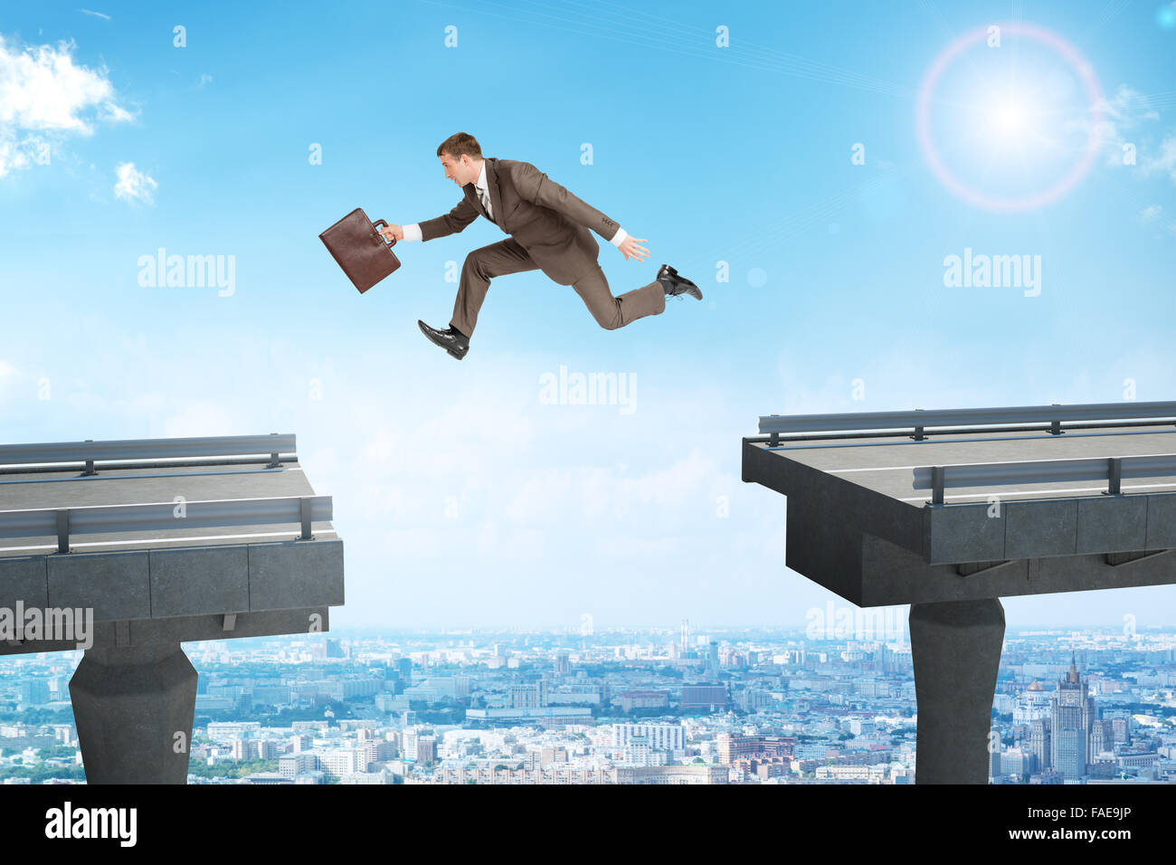 Image of young businessman jumping over gap Stock Photo - Alamy