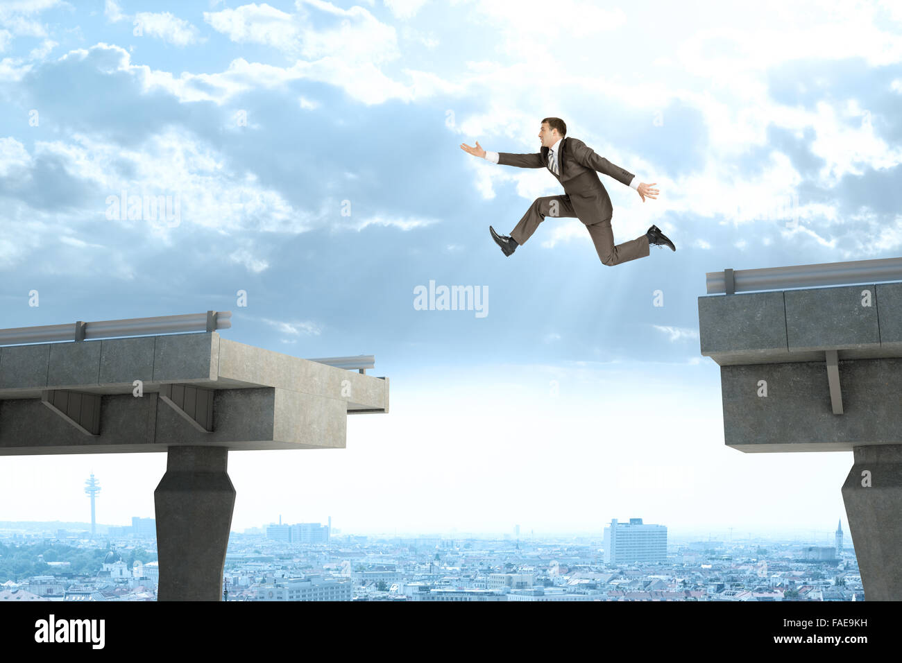 Image of young businessman jumping over gap Stock Photo - Alamy
