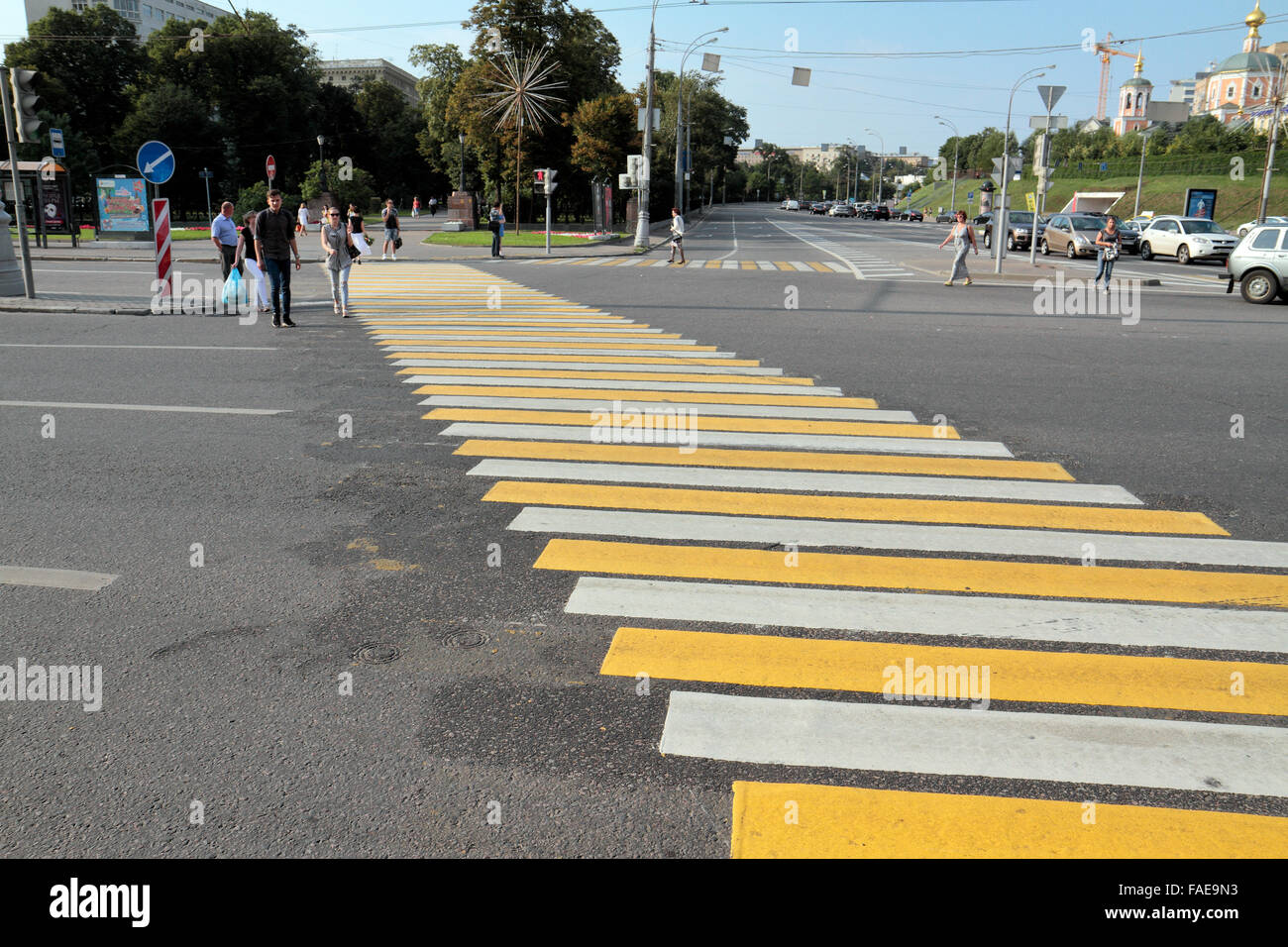 A white and yellow pedestrian crossing (a typical sight) in Moscow ...