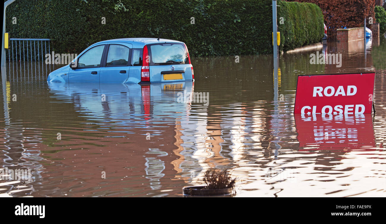A picture of the scene at a flooded road junction showing a stranded ...