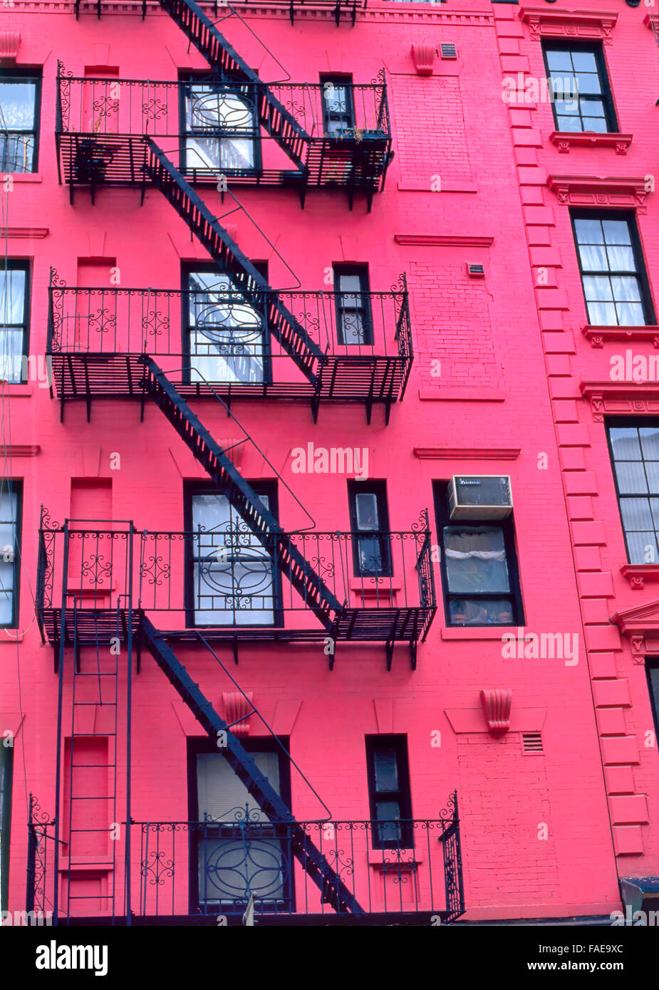 Fire Escapes Run Diagonally Down Colorful Apartment Buildings In
